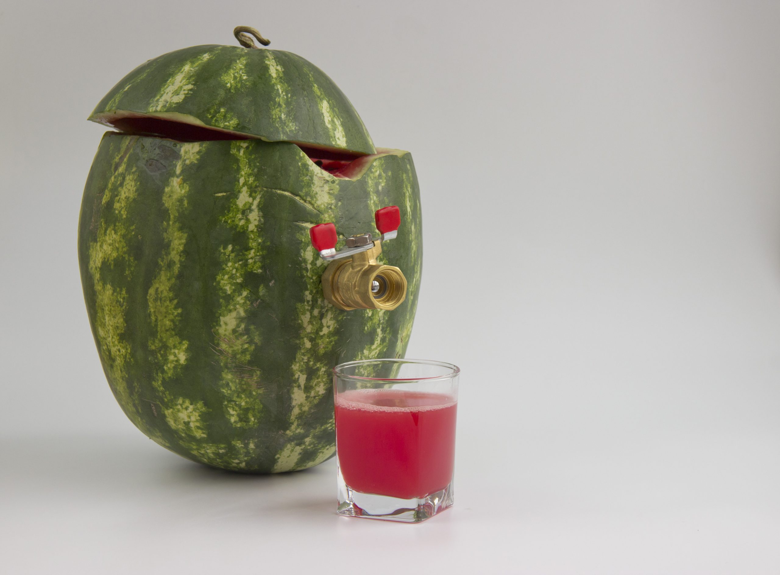 The watermelon c tap to fill the juice on a light background. - Mental ...